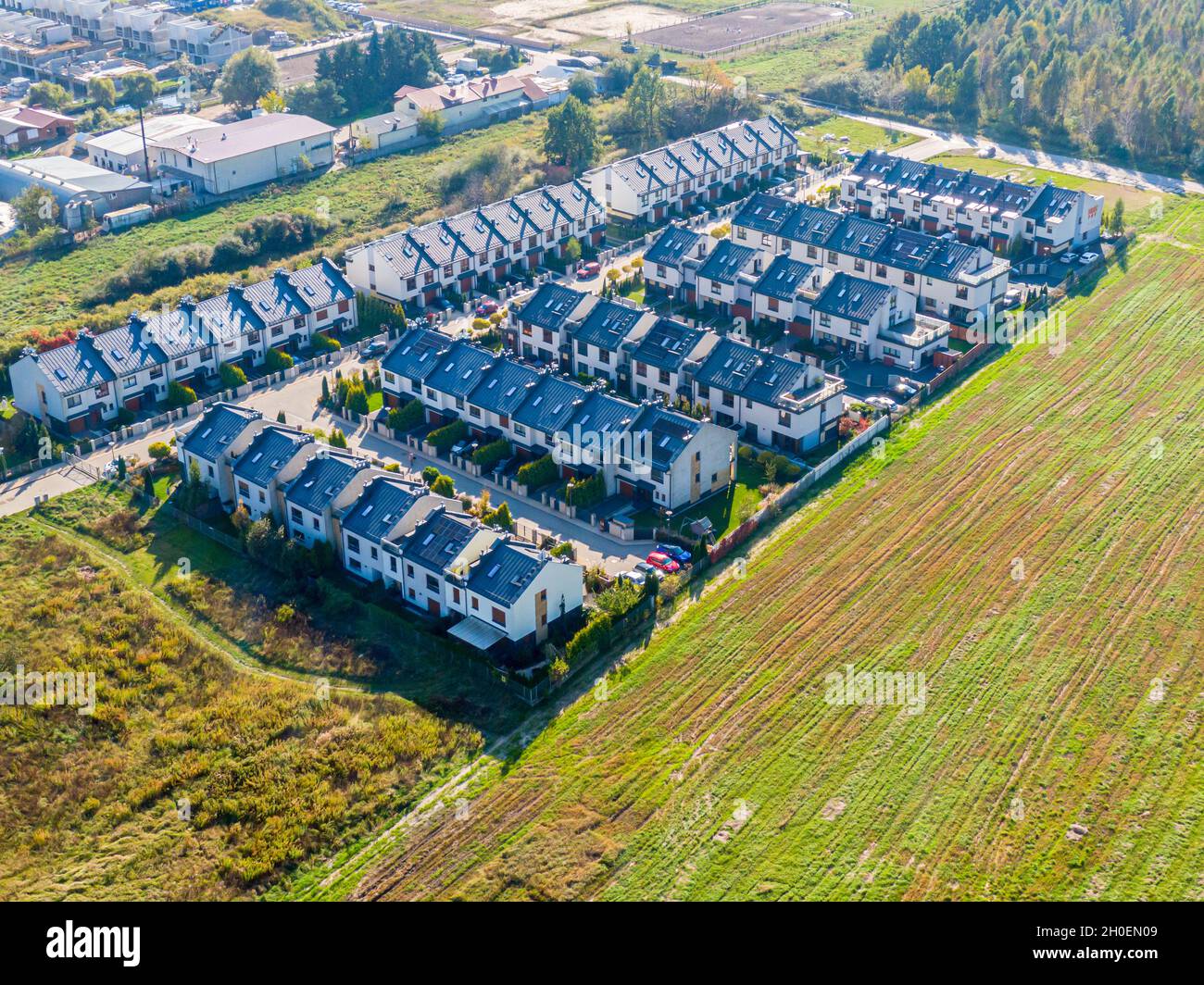 Aerial summer view of warm sunny neighborhood community roofs with ...