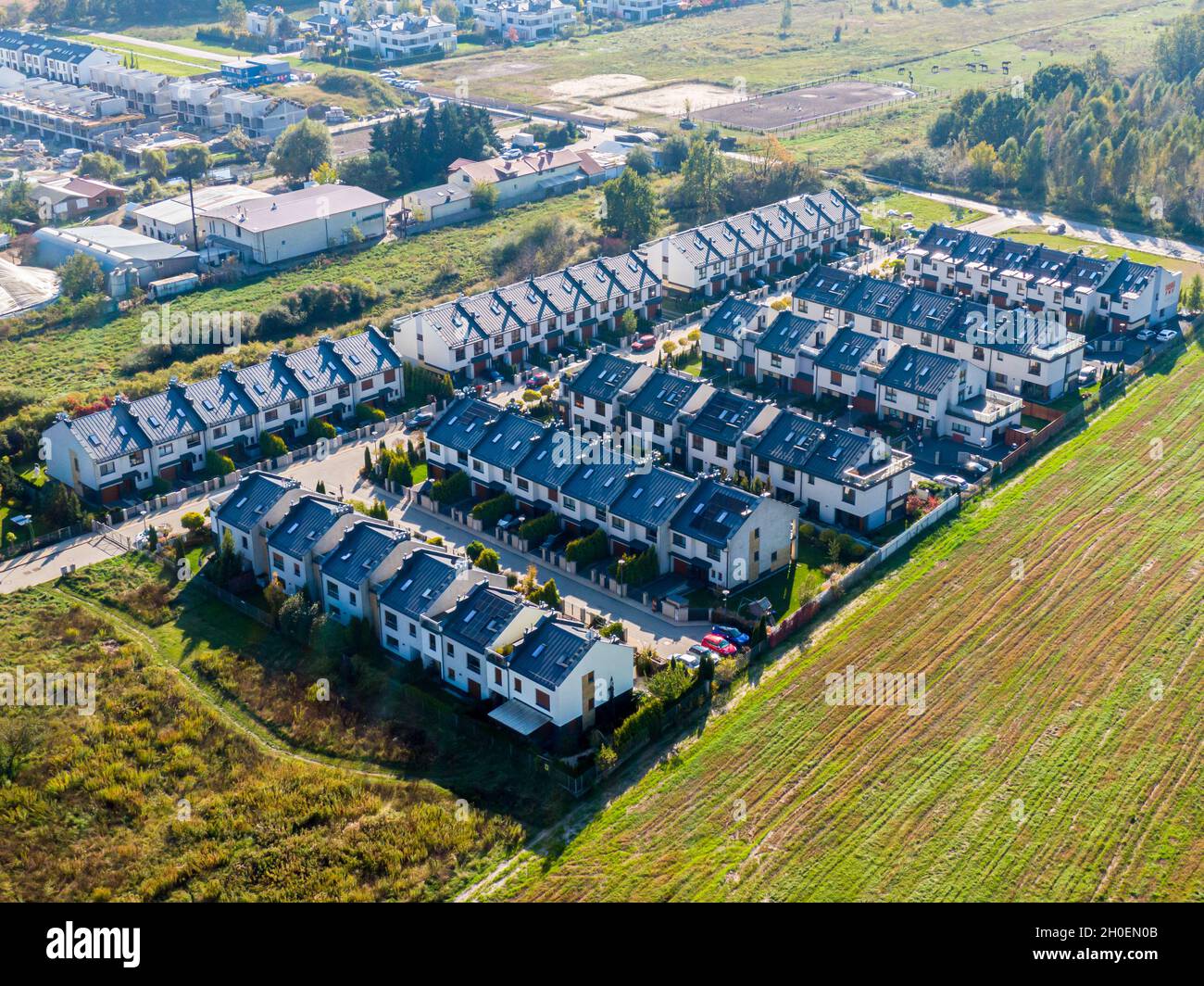 Aerial summer view of warm sunny neighborhood community roofs with ...