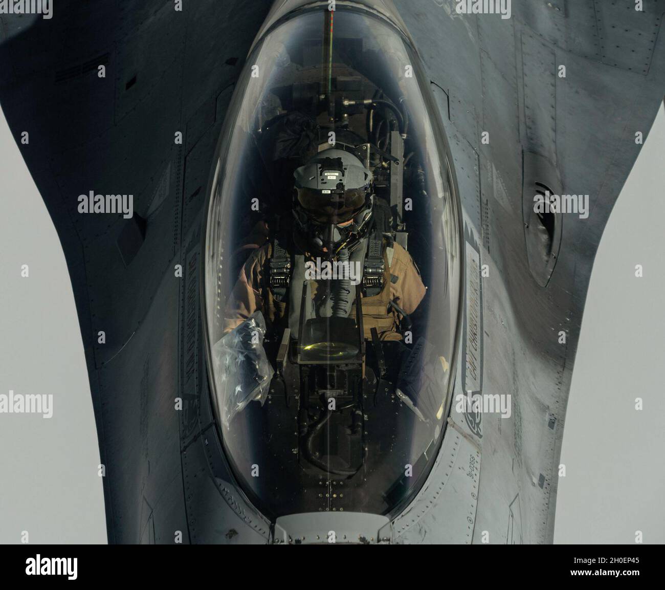 A U.S. Air Force F-16 Fighting Falcon pilot maneuvers his aircraft into ...