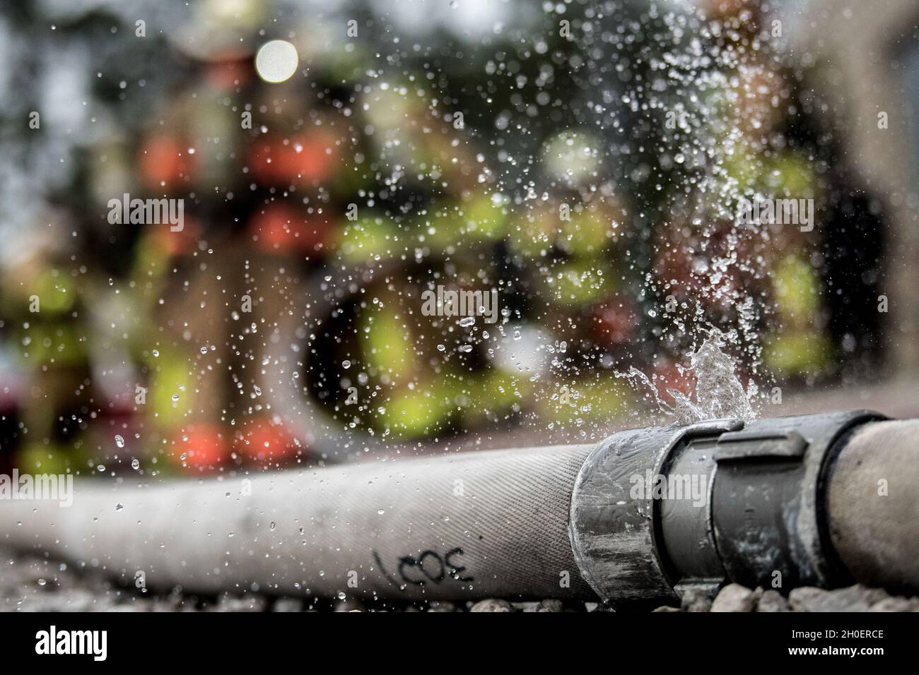 Water spurts out of a fire hose during a fire training exercise at ...