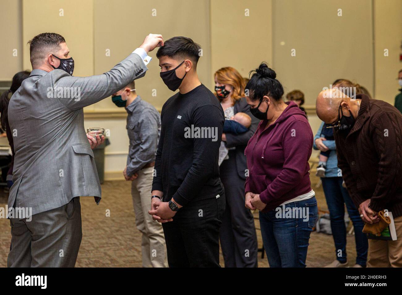 U.S. service members and families receive a marking of ashes during an ...