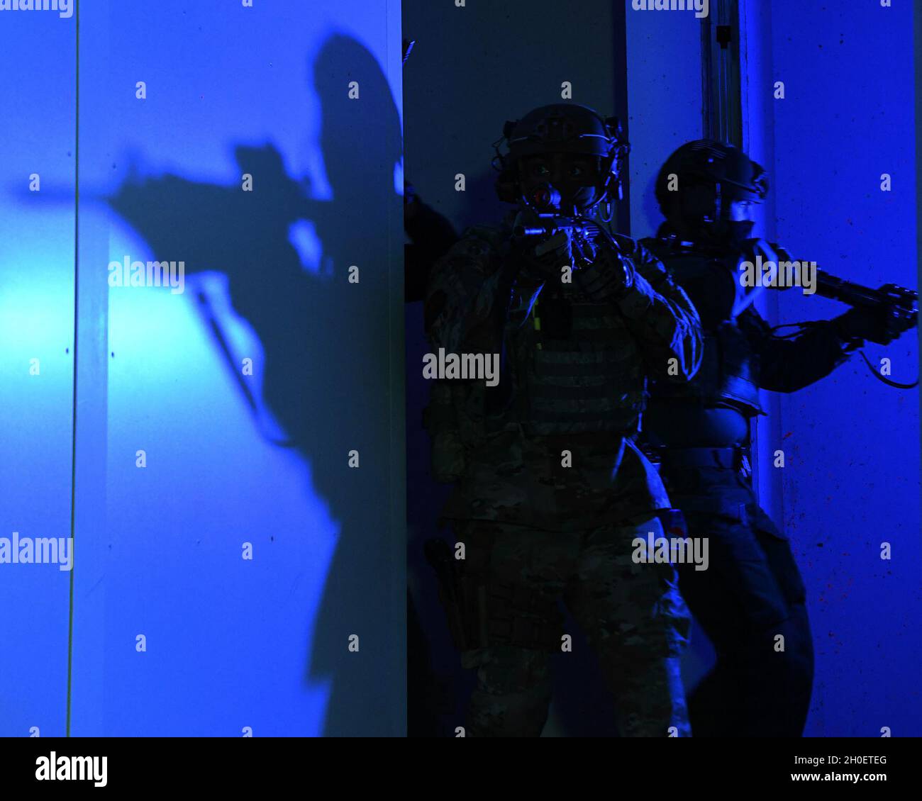 Airmen from the 460th Security Forces Squadron sweep a room in the ...