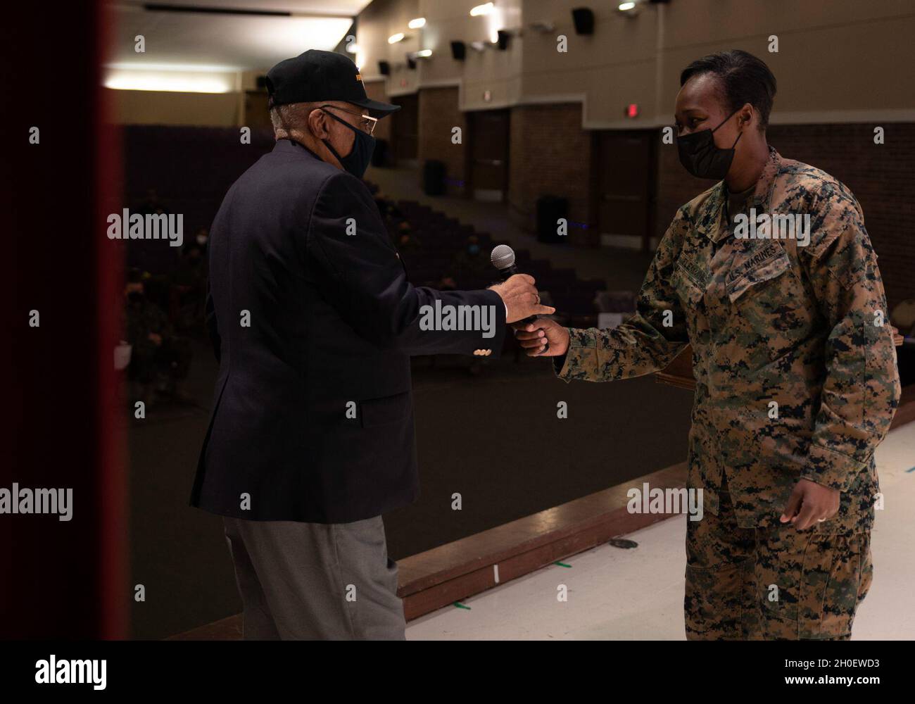 U.S. Marine Corps (ret.) Maj. James Capers Jr. (left) takes the stage ...