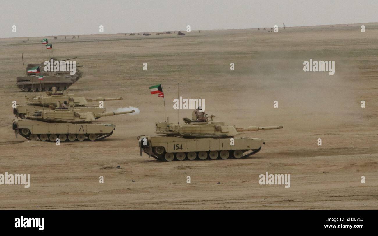 Kuwait Land Forces tanks, from 6th Mechanized Brigade, fire rounds down ...