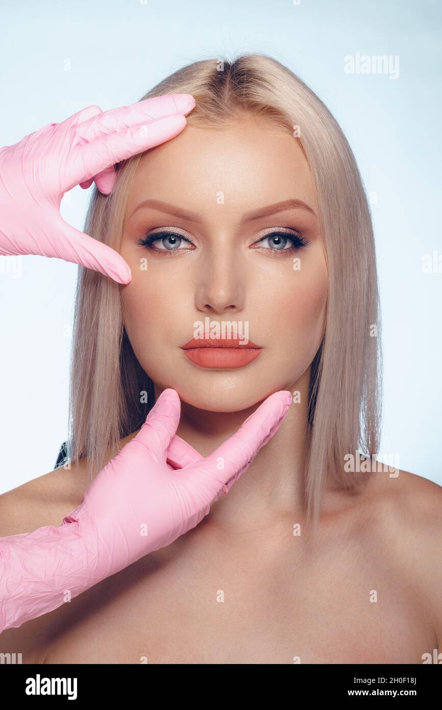 Beautiful woman with perfect smooth skin being checked by doctor ...