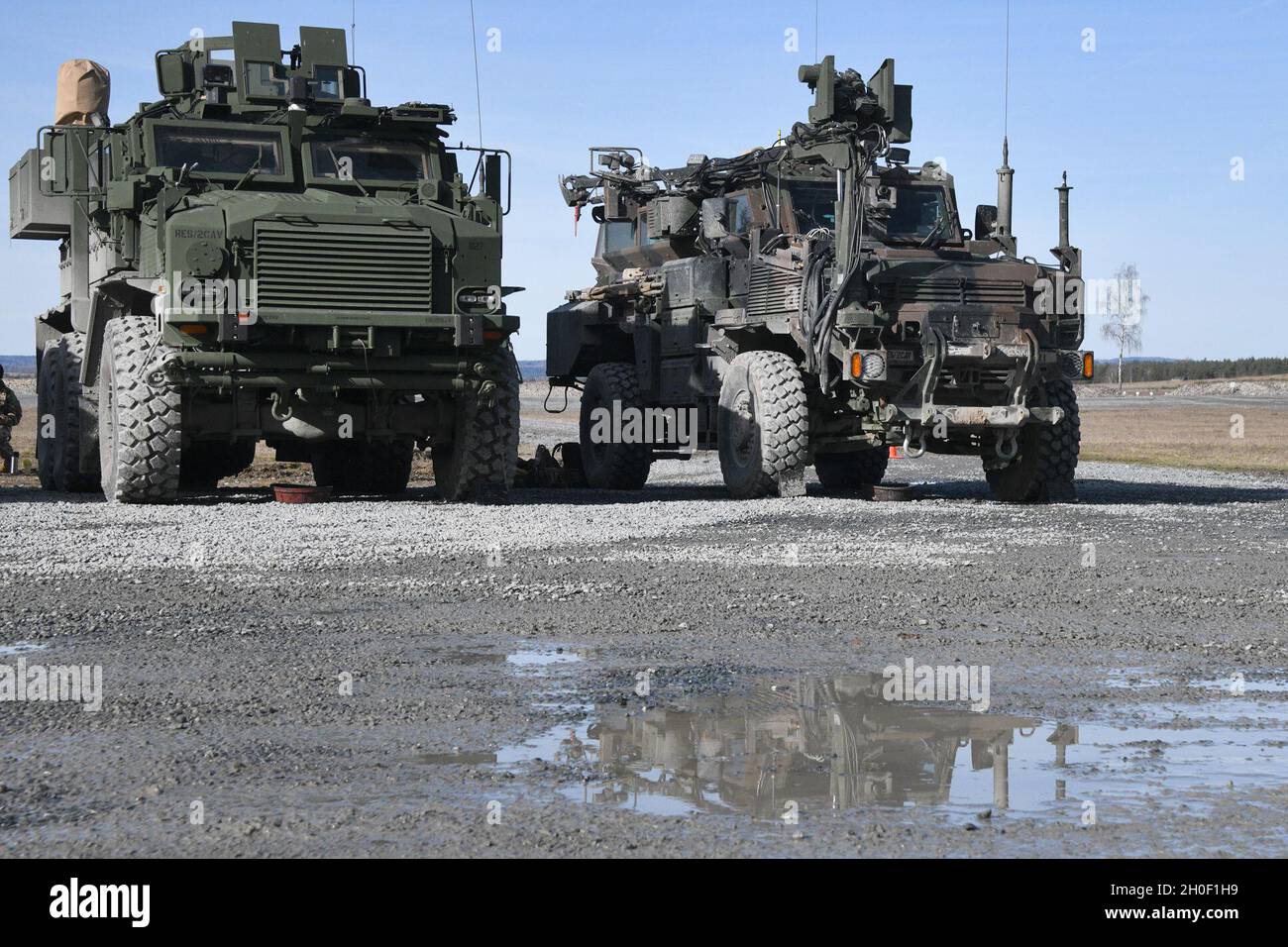 The photo displays a Medium Mine Protected Vehicle Type I, left, and a ...