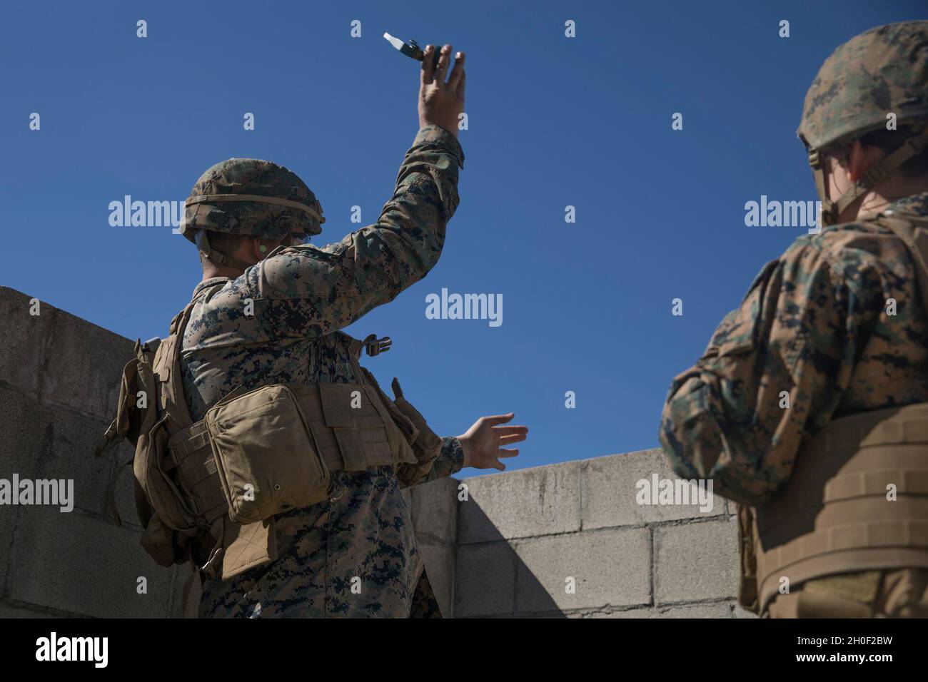 A U.S. Marine with Headquarters Battalion, 1st Marine Division, throws ...
