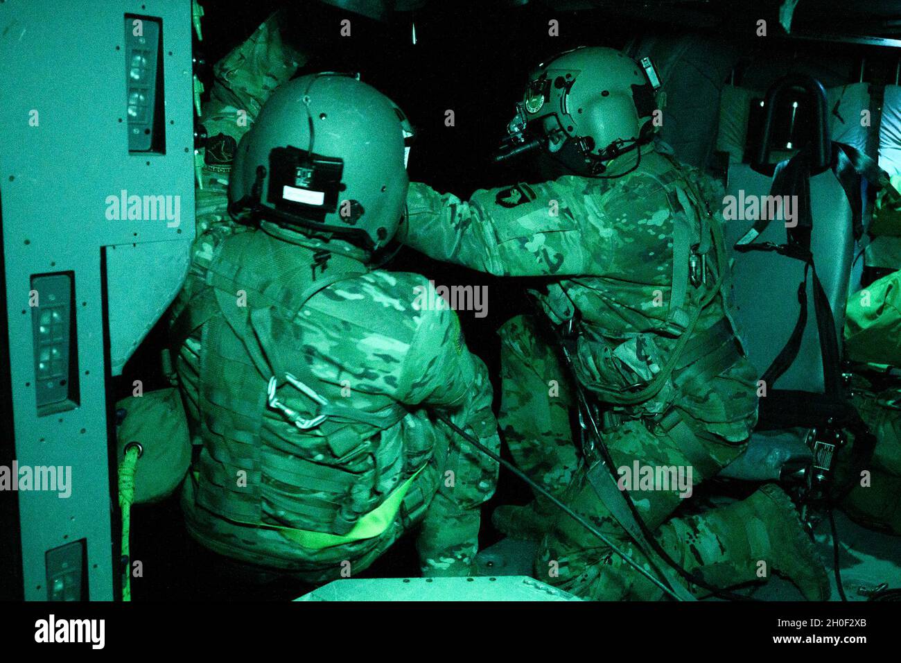 U.S. Army Sgt. Dakota Maatman lowers Staff Sgt. Taylor Mitchell, both ...