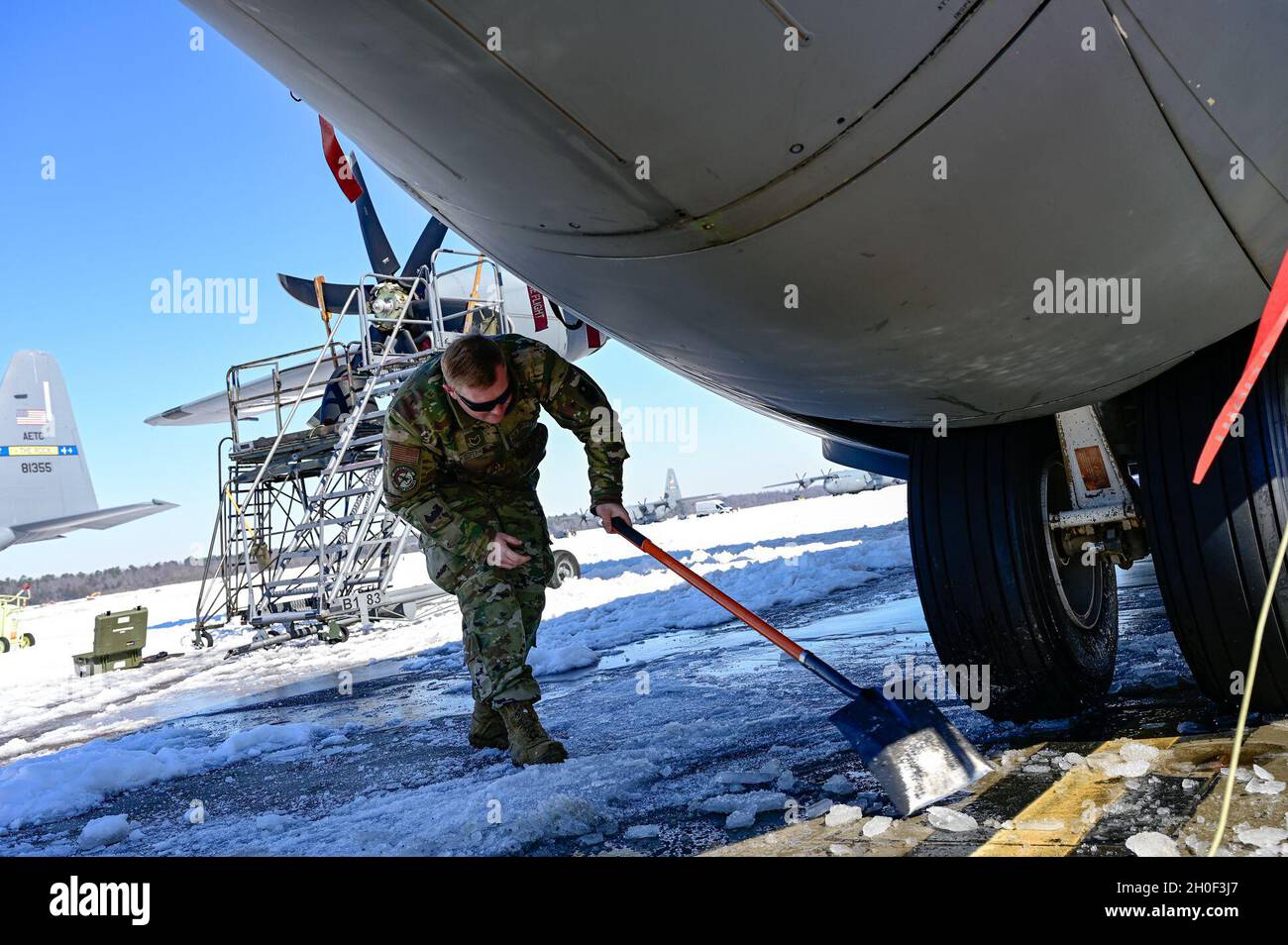 An Airman assigned to the 314th Airlift Wing clears ice from the ...