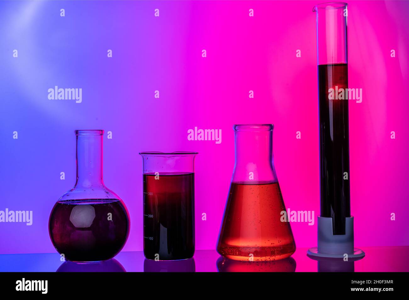 Laboratory glass tubes with chemicals on bright pink background Stock ...