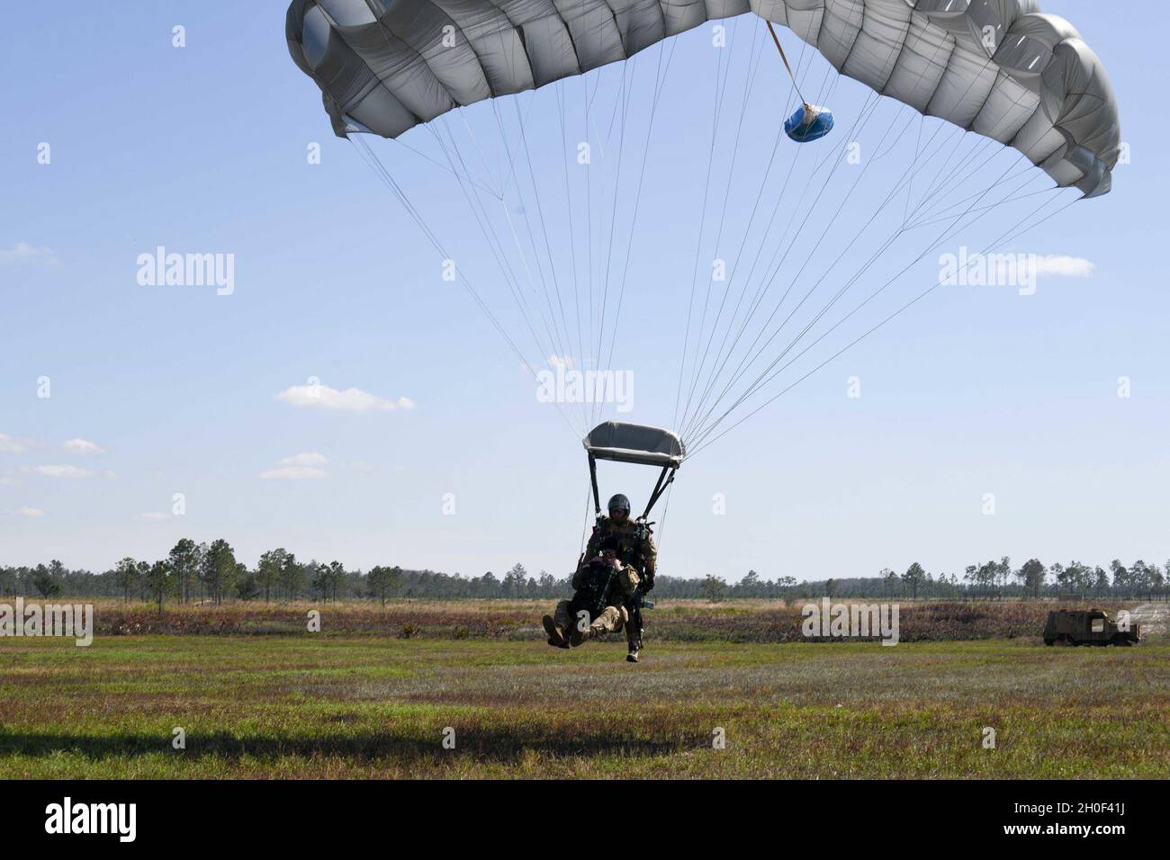 A 920th Aircraft Maintenance Squadron crew chief parachutes, in tandem ...