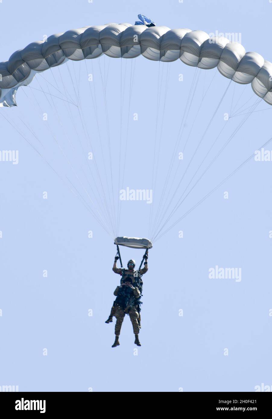 A 920th Aircraft Maintenance Squadron crew chief parachutes, in tandem ...