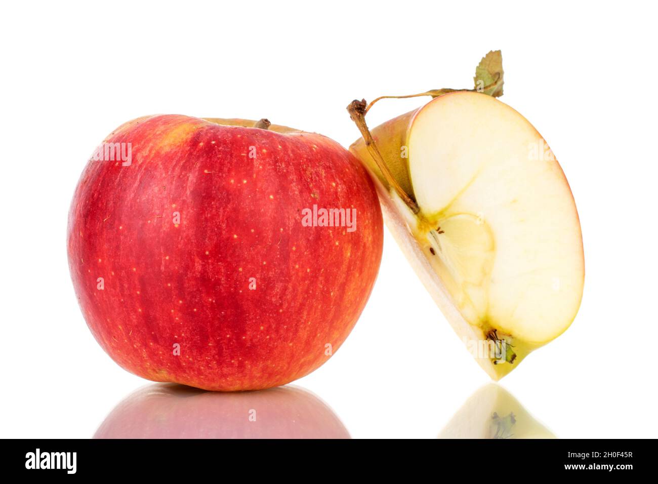 One sweet organic apple slice and one whole, close-up, isolated on ...