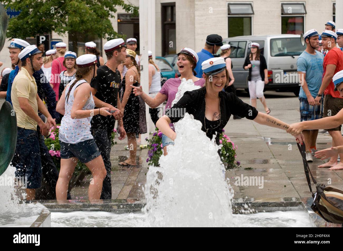 High school students celebrating graduation near a fountain in Aarhus ...