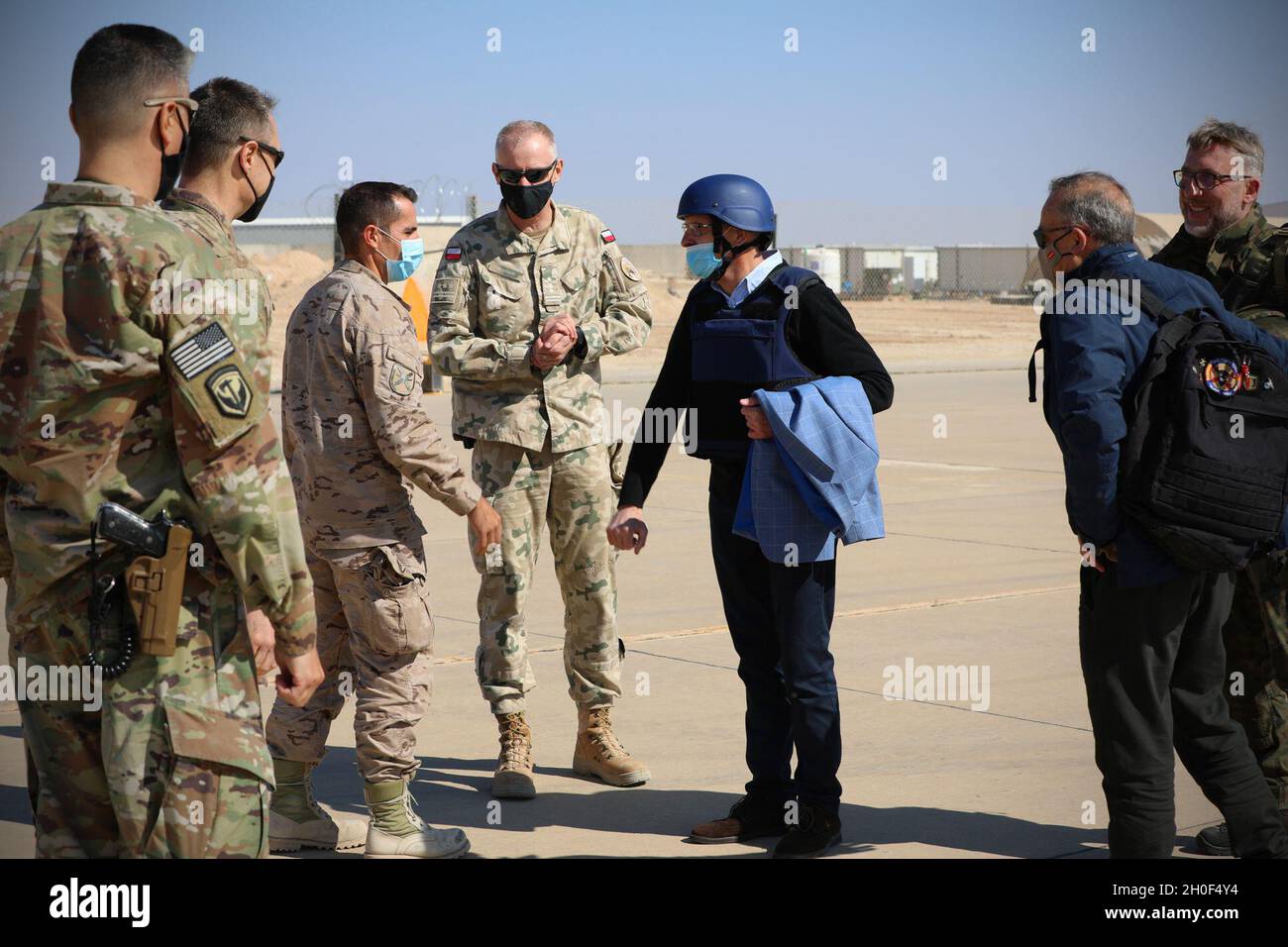 Poland’s Ambassador to Iraq, right, honorable Marcin Kubiak greets the ...