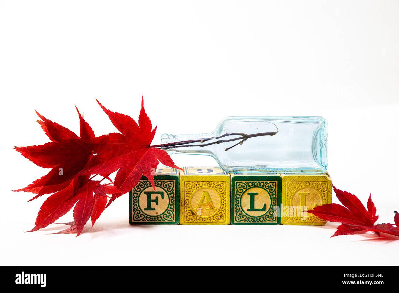 Red Maple Leaves with an Old Blue Bottle and Blocks Spelling Fall Stock ...