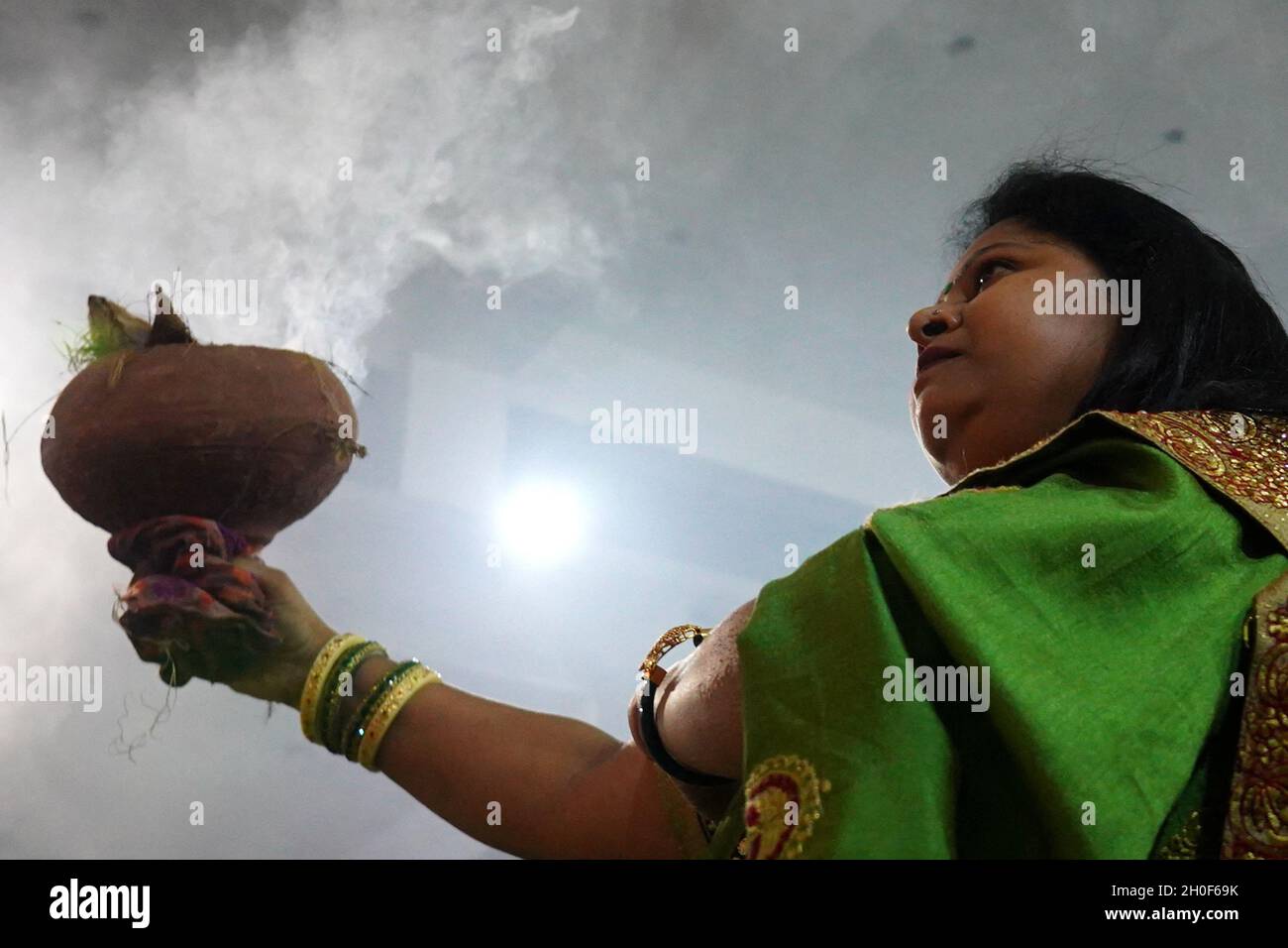 Hindu devotee performs a traditional Dhunuchi dance inside a temporary ...