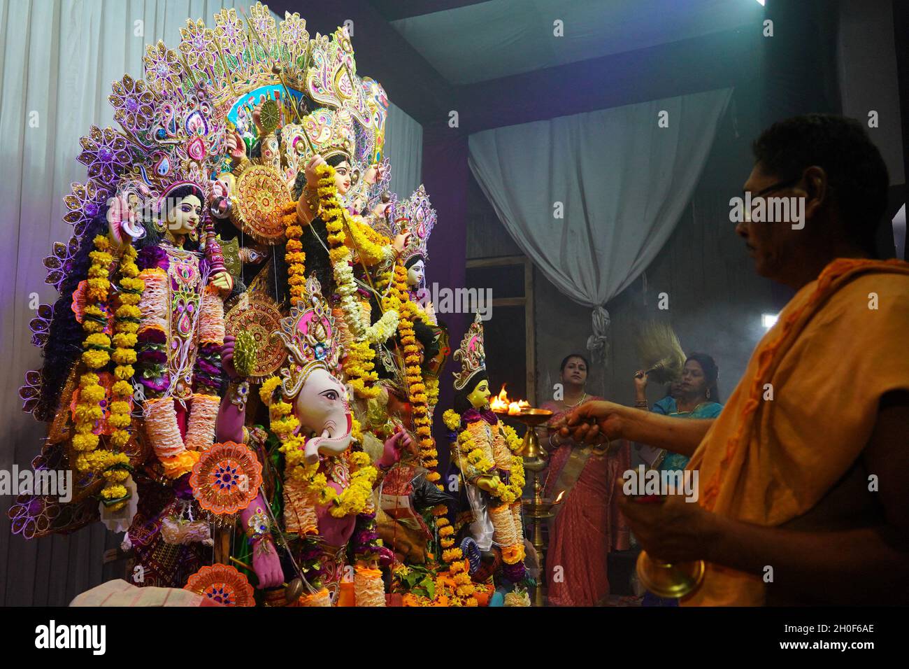 Indian People Perform Rituals in front of an idol of the Goddess Durga ...