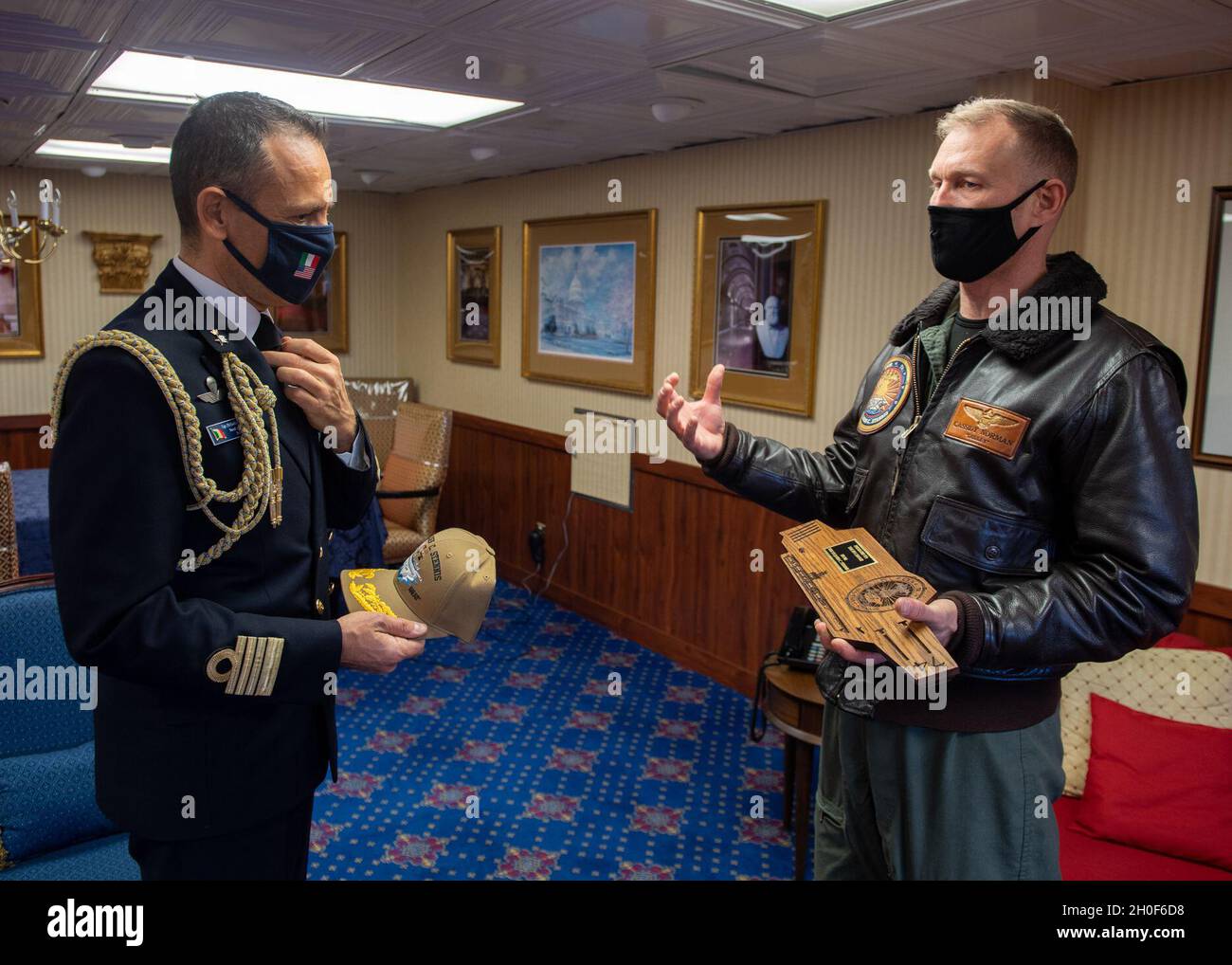 Italian Navy Capt. Gianfranco Vizzini, naval attaché, left, speaks with ...