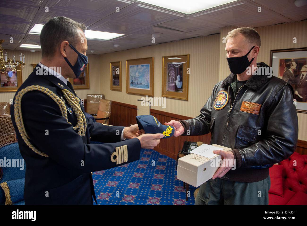 Italian Navy Capt. Gianfranco Vizzini, naval attaché, left, presents a ...