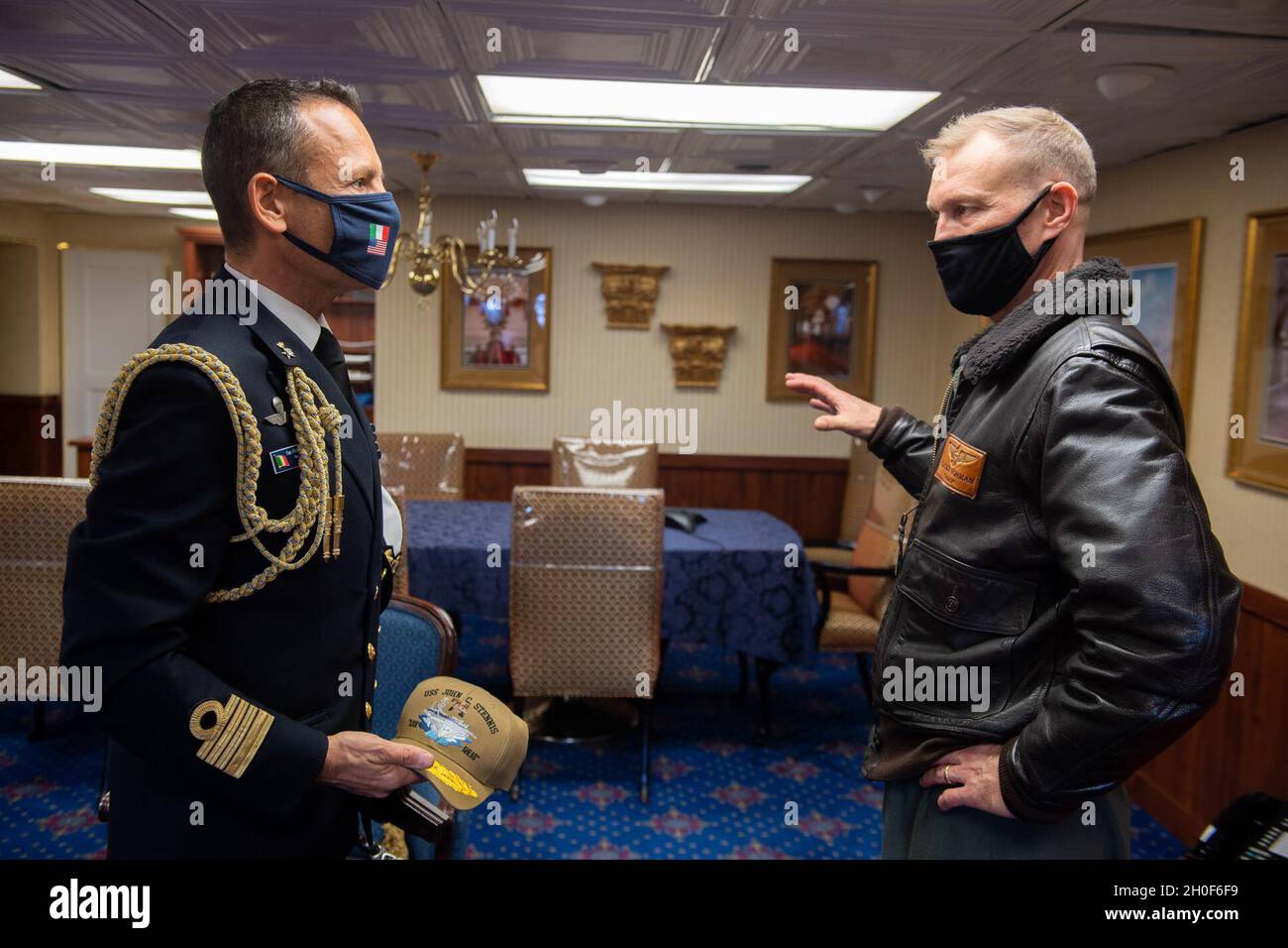 Italian Navy Capt. Gianfranco Vizzini, naval attaché, left, speaks with ...