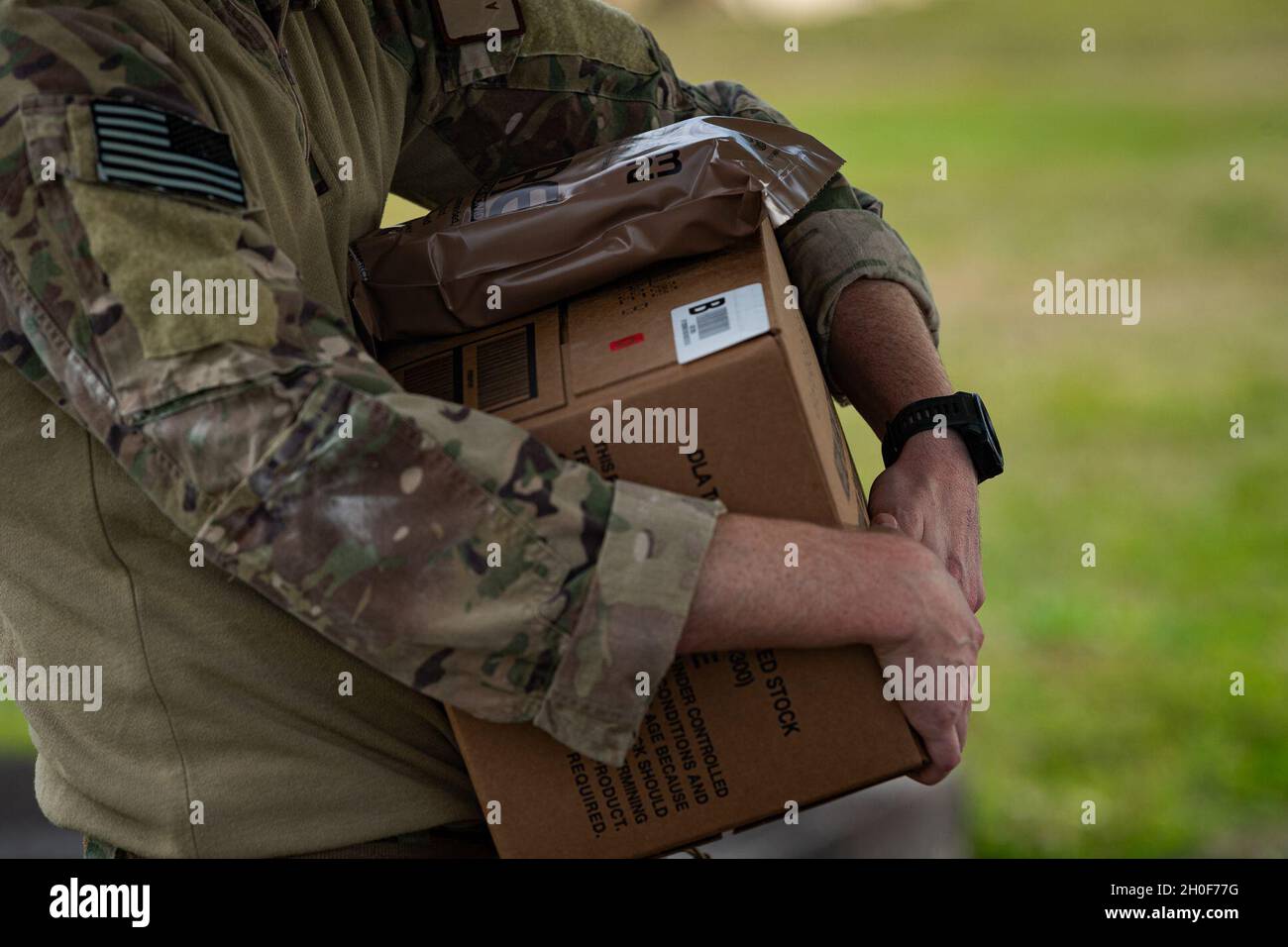 Capt. Jesse Reynolds, 41st Rescue Squadron pilot, holds a box of Meals ...