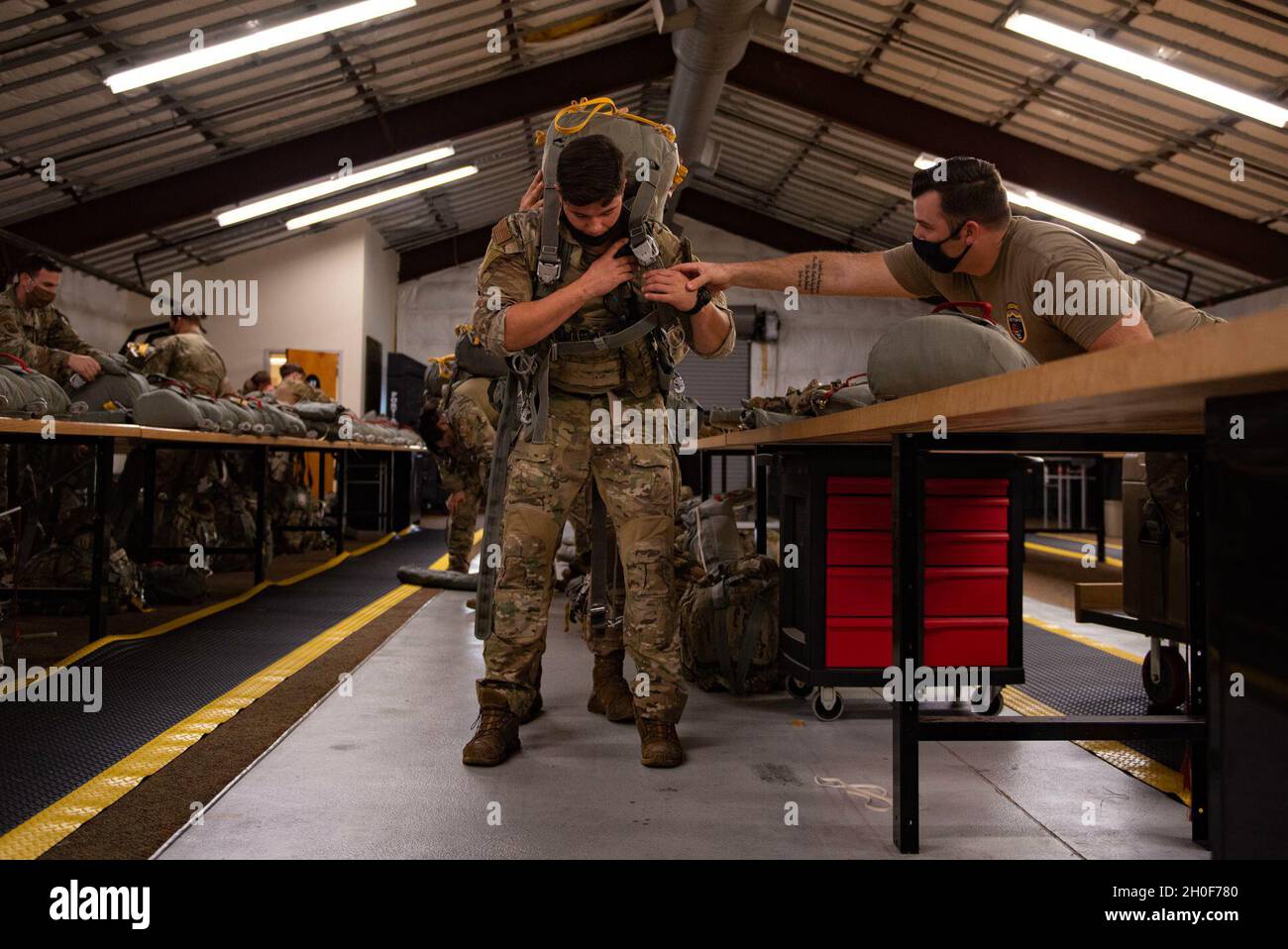 An Airman assigned to the 820th Base Defense Group receives help while ...