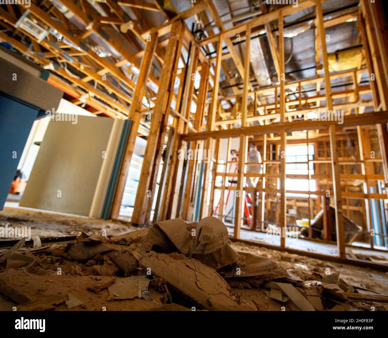 Damaged drywall is collected during the demolition phase of ...