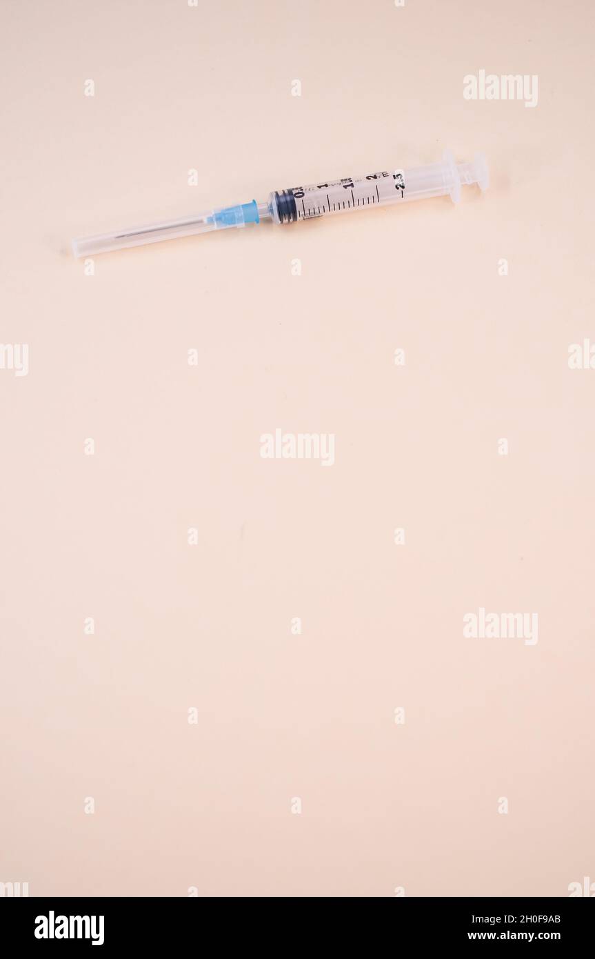 isolated sterilized injection syringe on a beige background Stock Photo ...