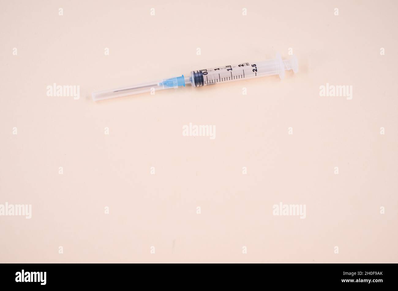 isolated sterilized injection syringe on a beige background Stock Photo ...