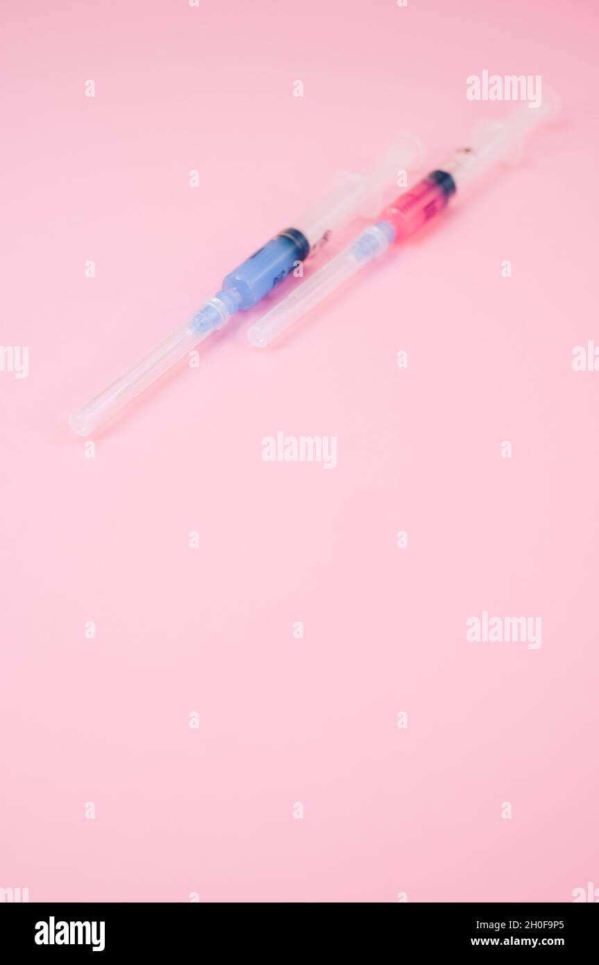 sterilized injection syringe on a pink background Stock Photo - Alamy