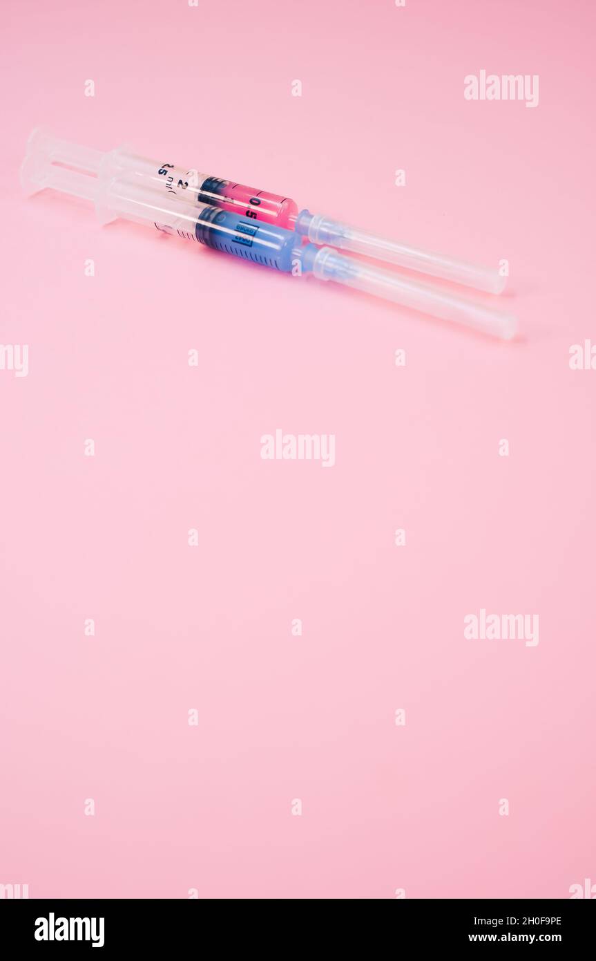 sterilized injection syringe on a pink background Stock Photo - Alamy