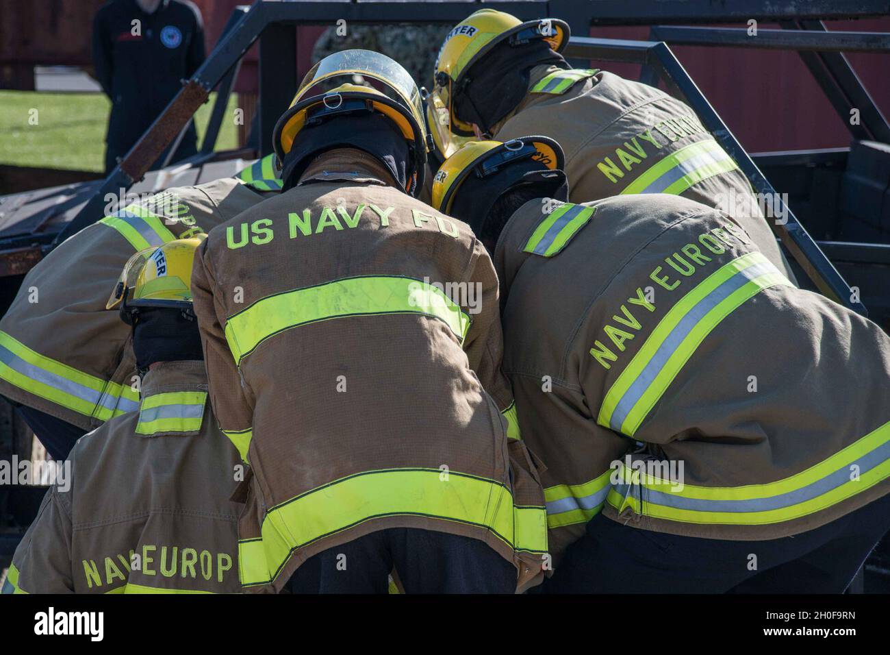 Naval Support Activity (NSA) Naples firefighters extract a simulated ...
