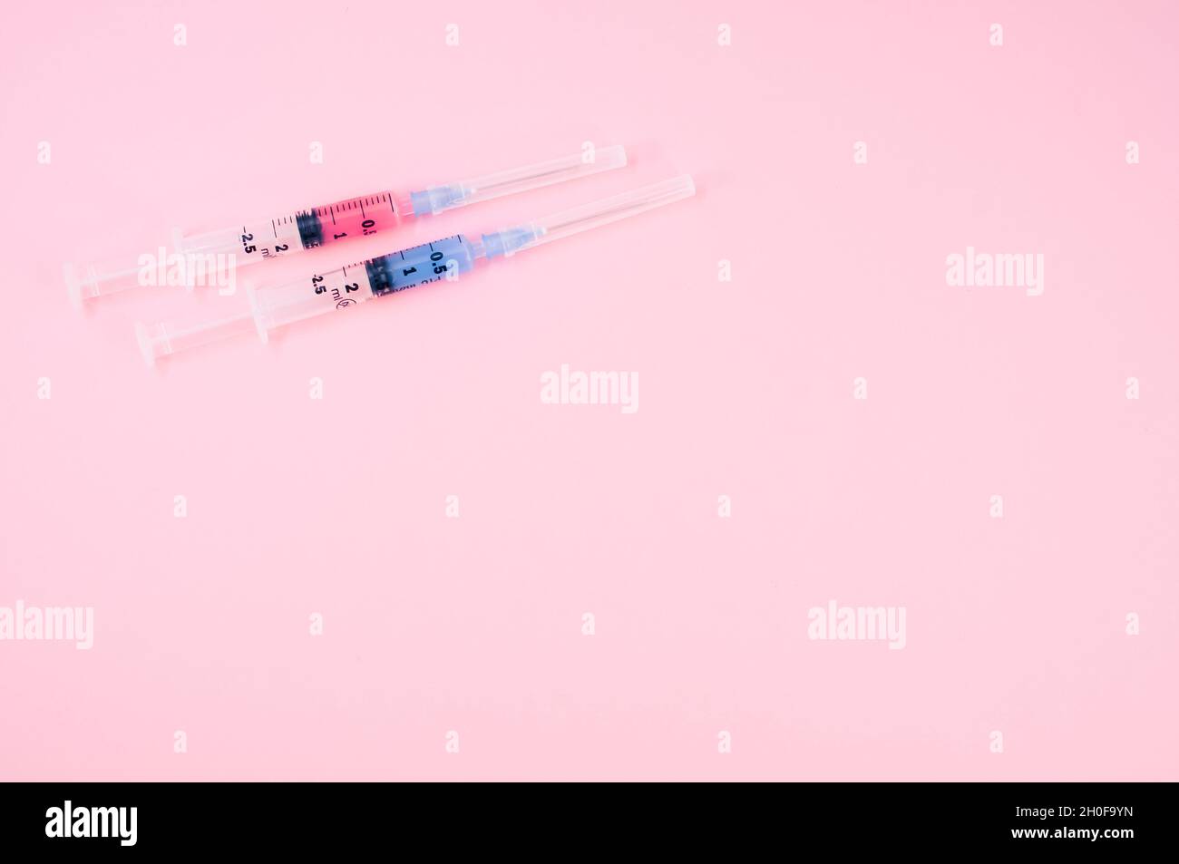 sterilized injection syringe on a pink background Stock Photo - Alamy