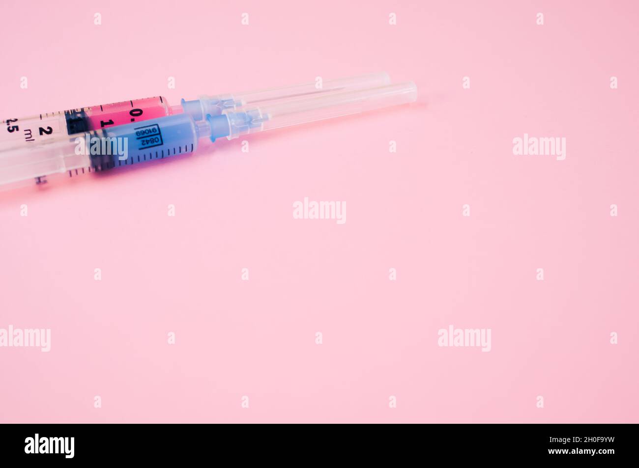 sterilized injection syringe on a pink background Stock Photo - Alamy