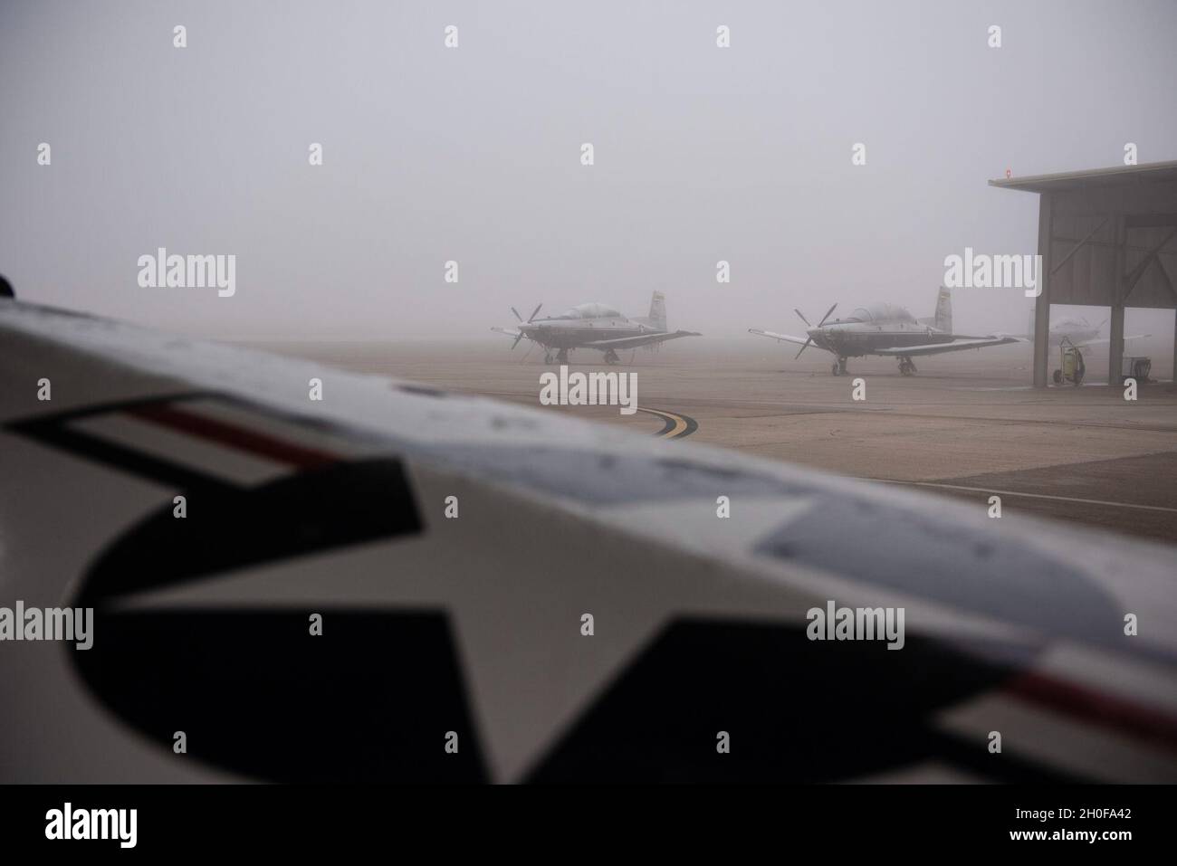 Lone T-6’s sit on the flight line await clear skies before take off on ...