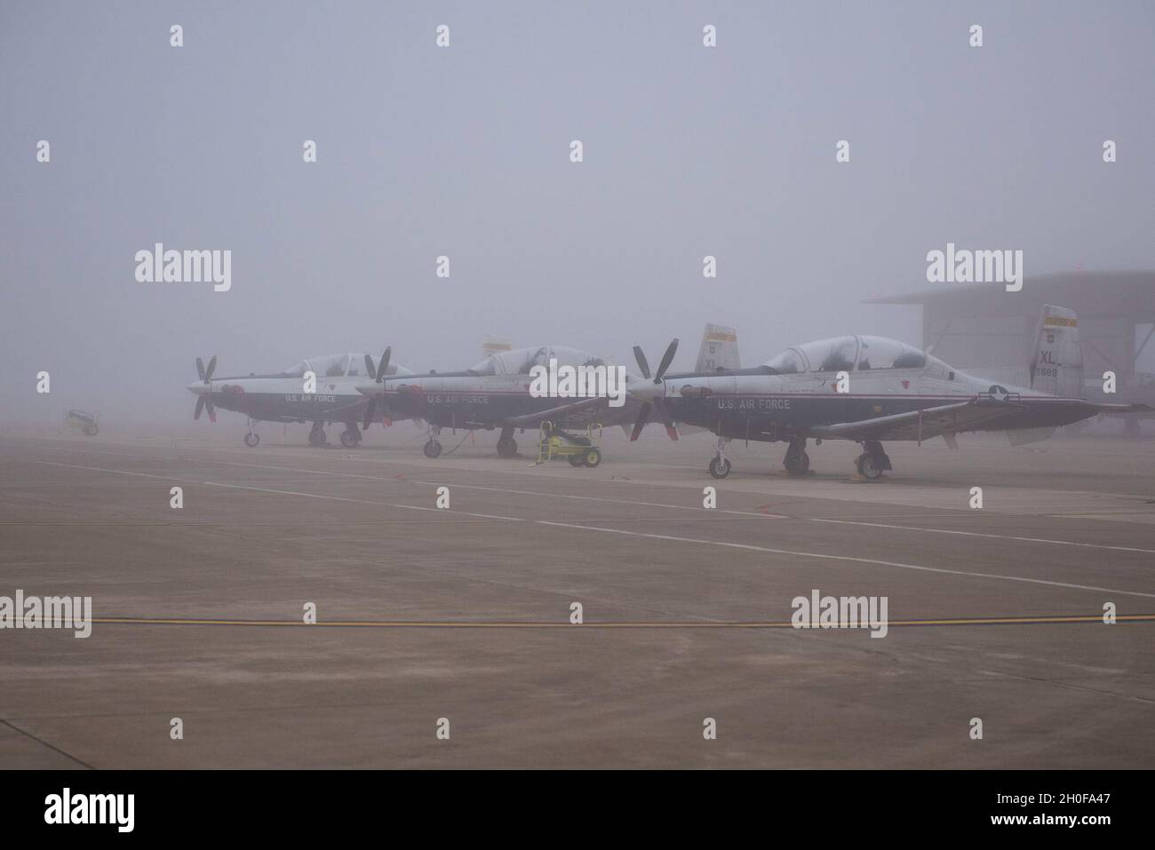 Lone T-6’s sit on the flight line await clear skies before take off on ...