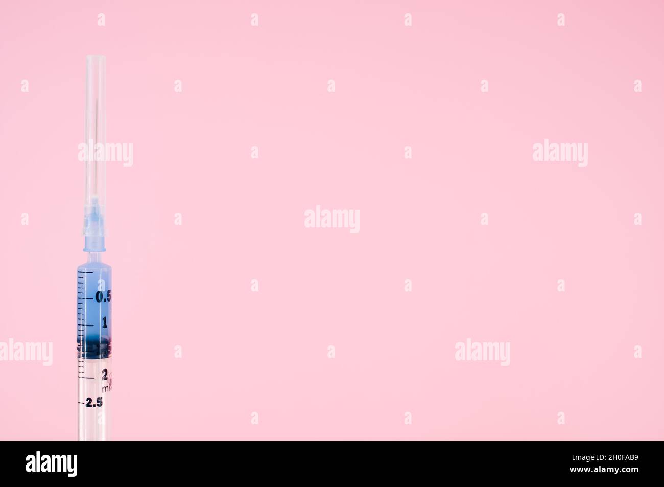sterilized injection syringe on a pink background Stock Photo - Alamy