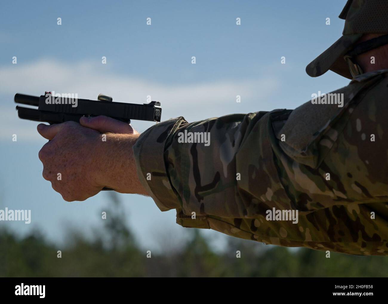 A representative assigned to the 7th Special Forces Group fires a Glock ...