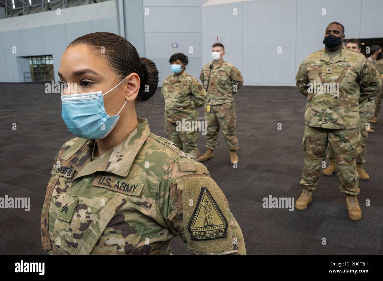 U.S. Army Sgt. Ashley Santos, recruiter, leads a formation of 10 New ...