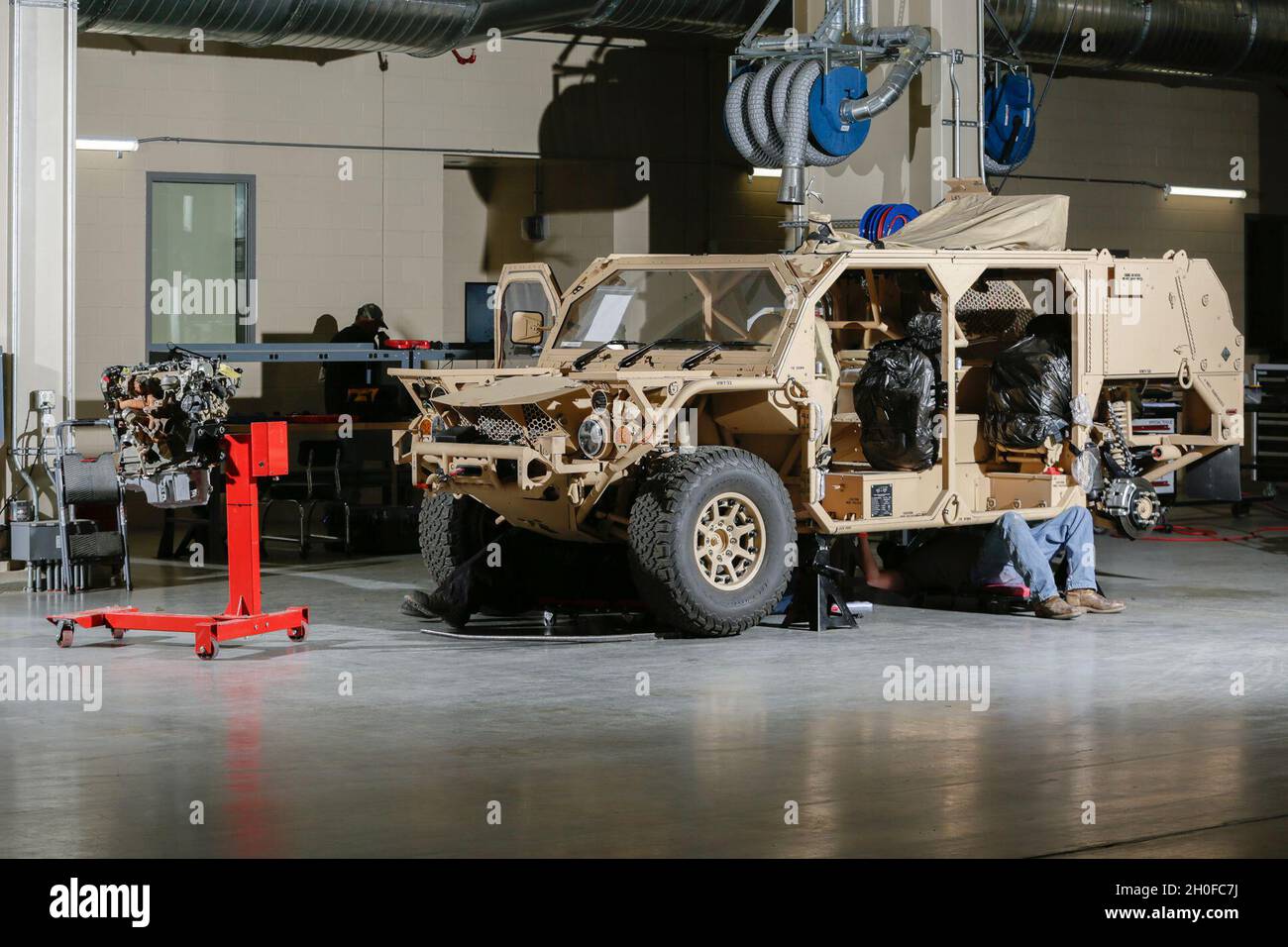 Heavy Mobile Equipment mechanics work with Flyer Defense personnel to ...