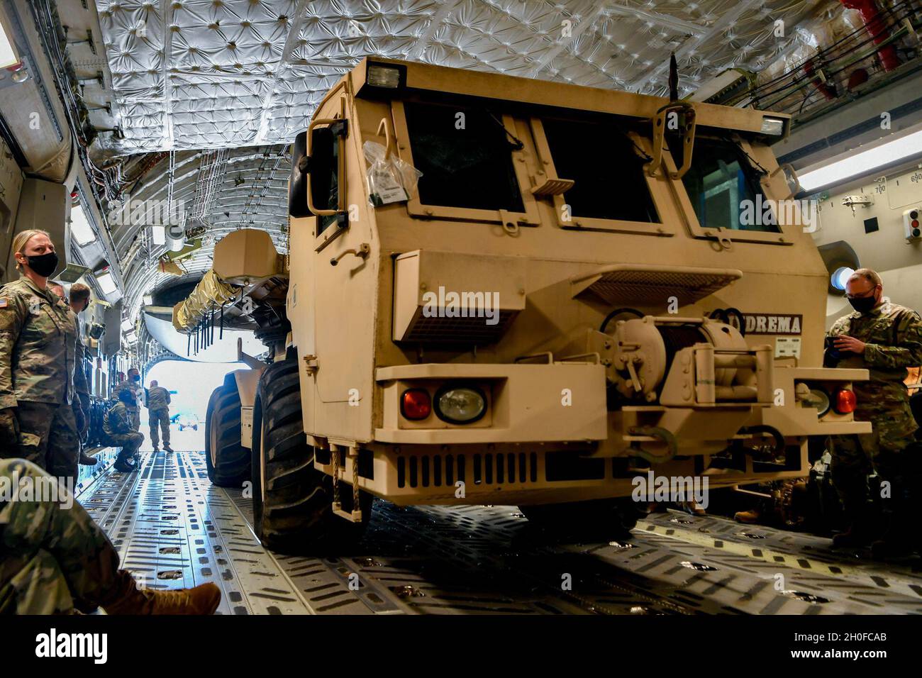 A U.S. Army minesweeper connected to a Heavy Expanded Mobility Tactical ...