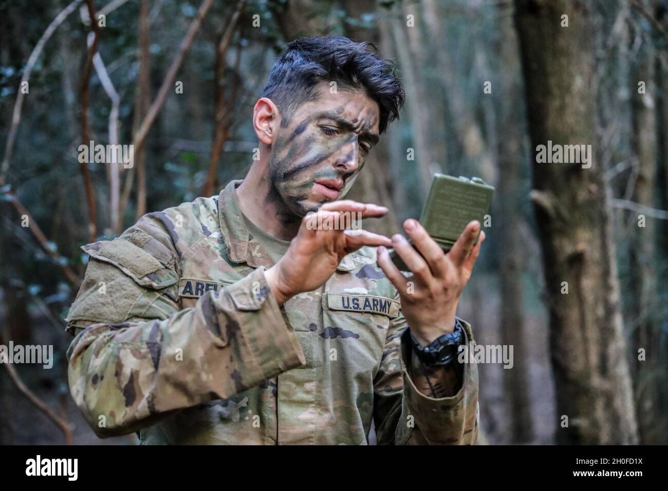 A Jungle Operations Training Course candidate applies face paint on Feb ...