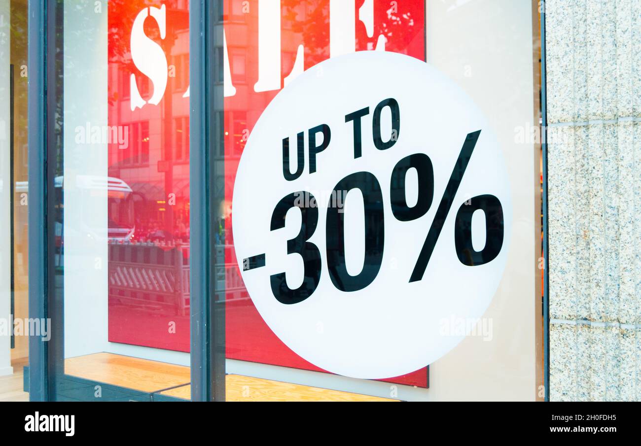 A big discount label in showcase of a store Stock Photo - Alamy