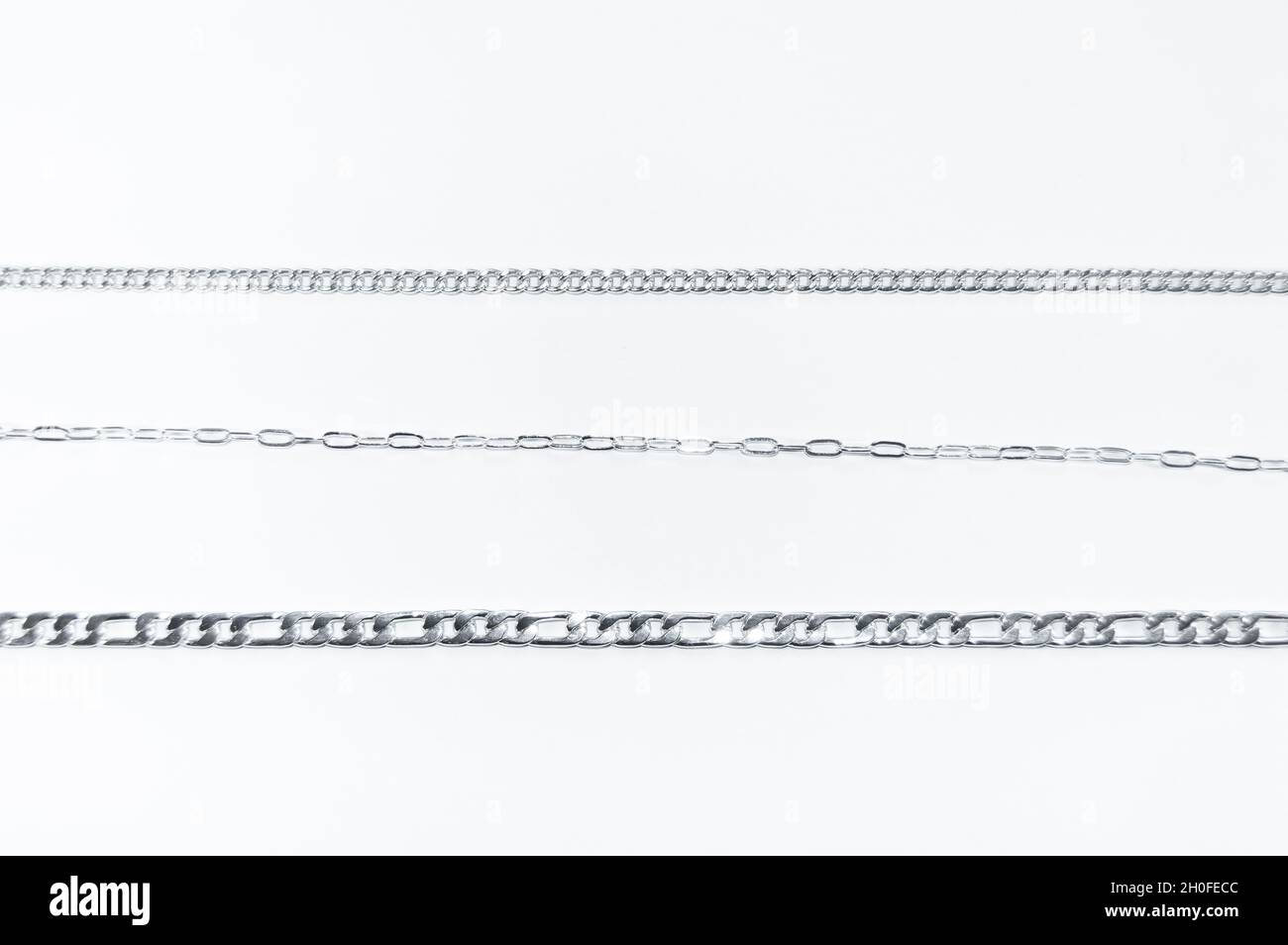 Variety of silver chains with white background Stock Photo - Alamy