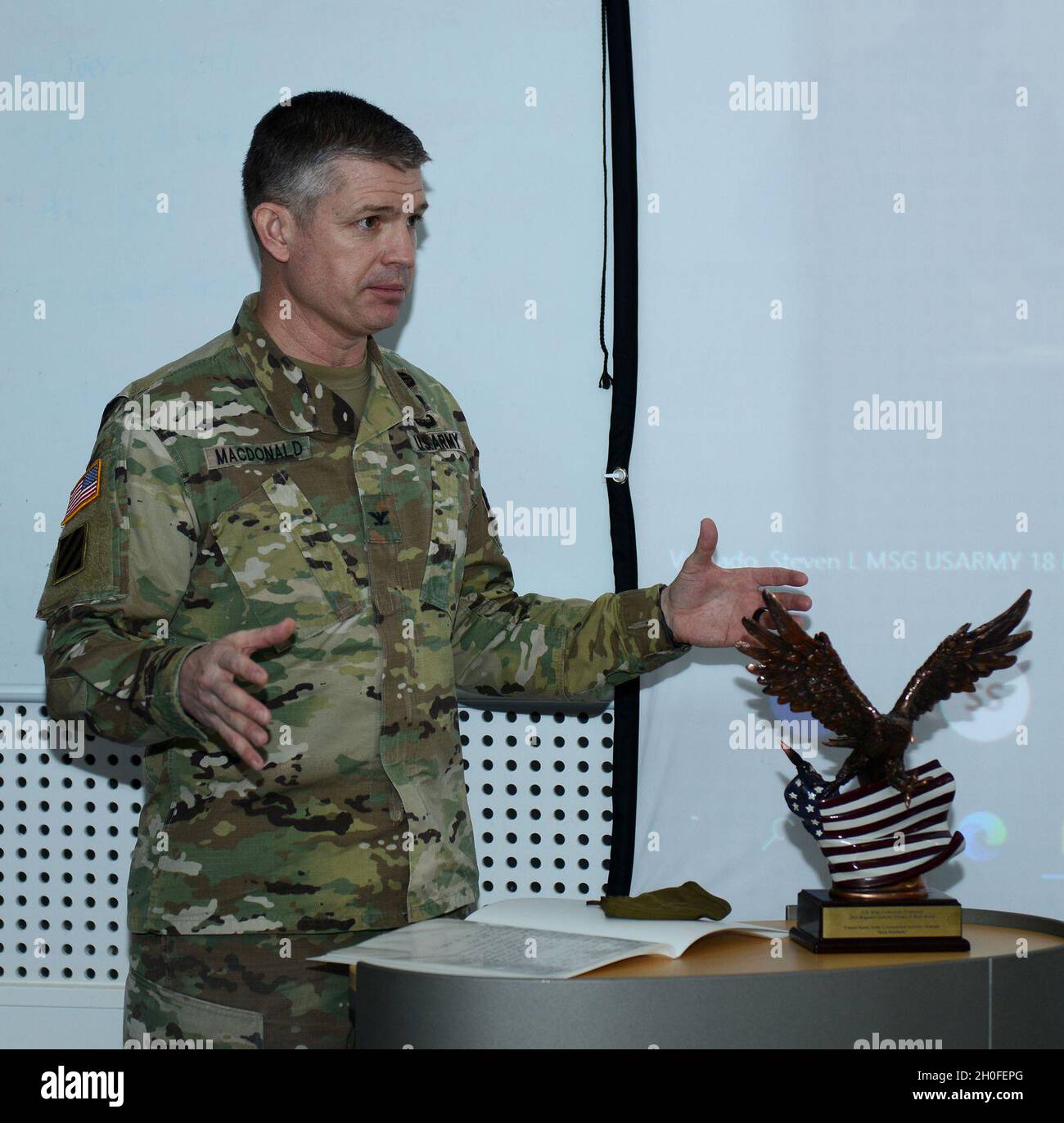 U.S. Army Col. Timothy MacDonald, 18th Military Police Brigade commander addresses the audience ...