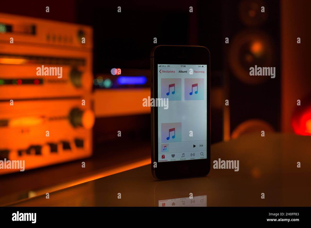 Smartphone as remote control for home sound system. Colorful background ...