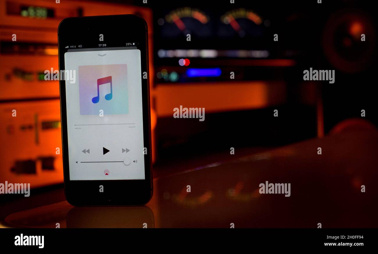 Smartphone as remote control for home sound system. Colorful background ...