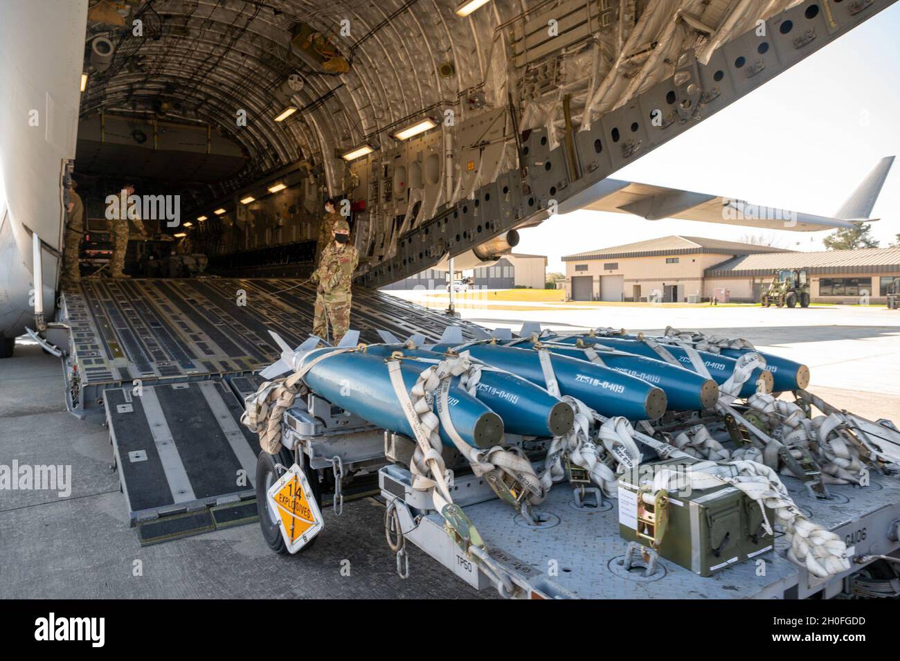 Inert training bombs are being loaded onto a Dover Air Force Base C-17 ...