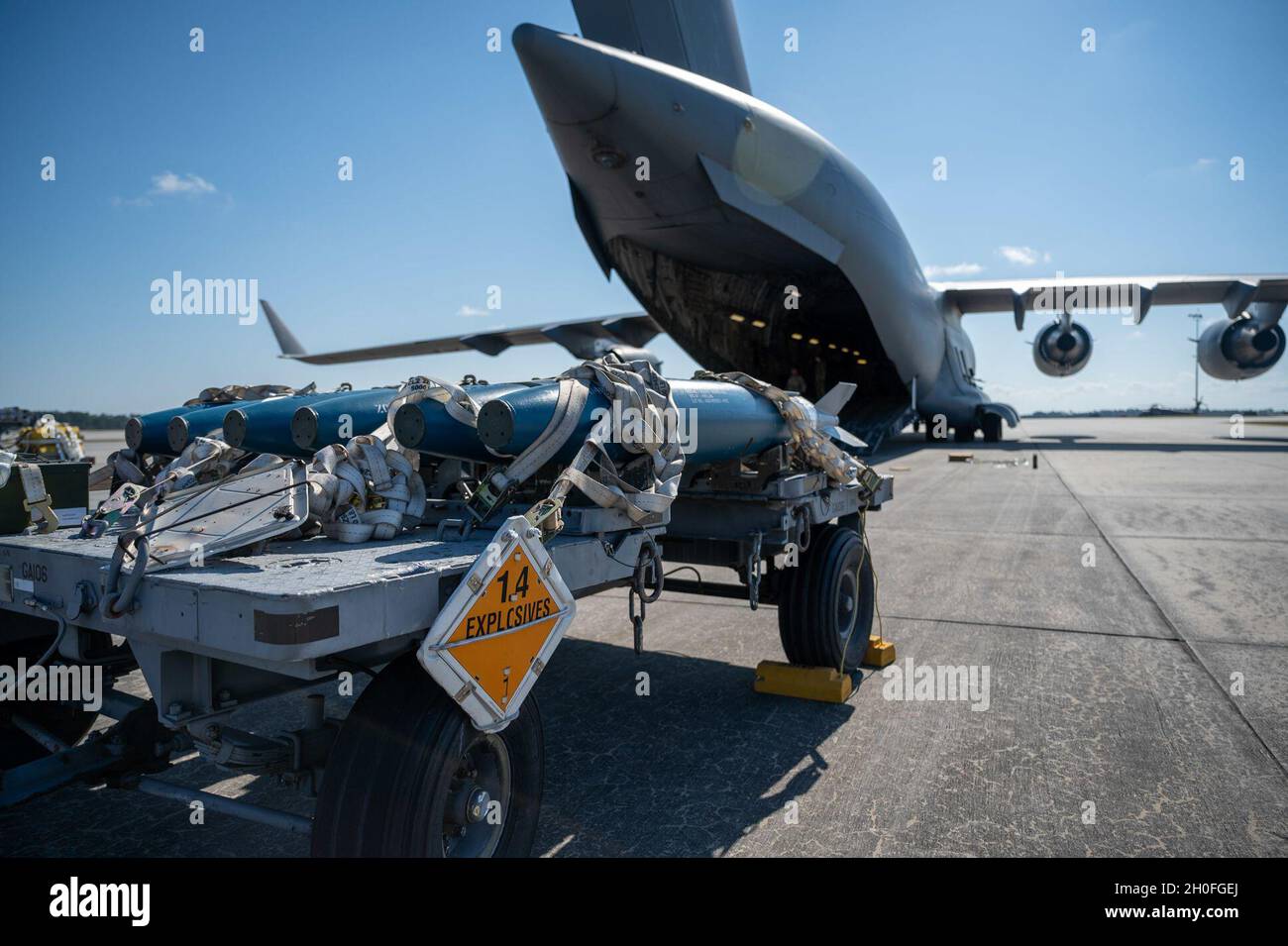 Inert training bombs are prepared for loading onto a Dover Air Force ...